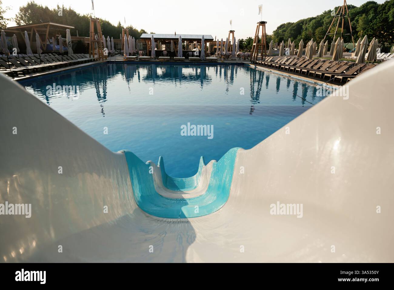 Pool slide, clean water in the vacation place, distant view Stock Photo ...