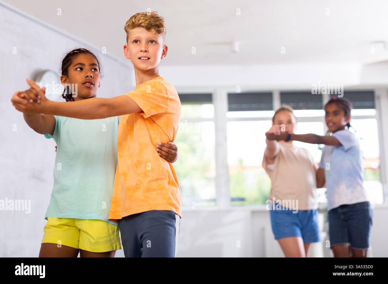 Tween girl and boy dancing slow ballroom dances in pair Stock Photo - Alamy