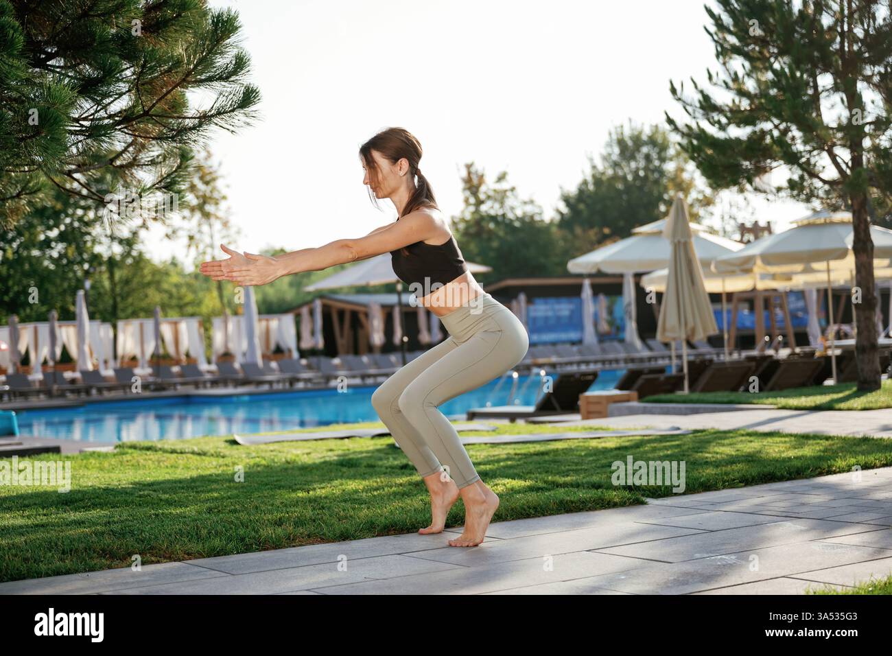 Concentrated at exercises. Fitness woman is outdoors, beautiful ...