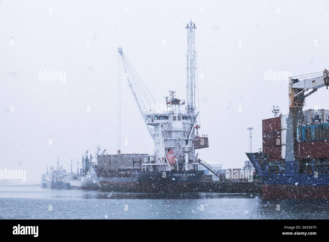 Reykjavik, Iceland - April 4, 2017: Snow falls during winter as cargo ...