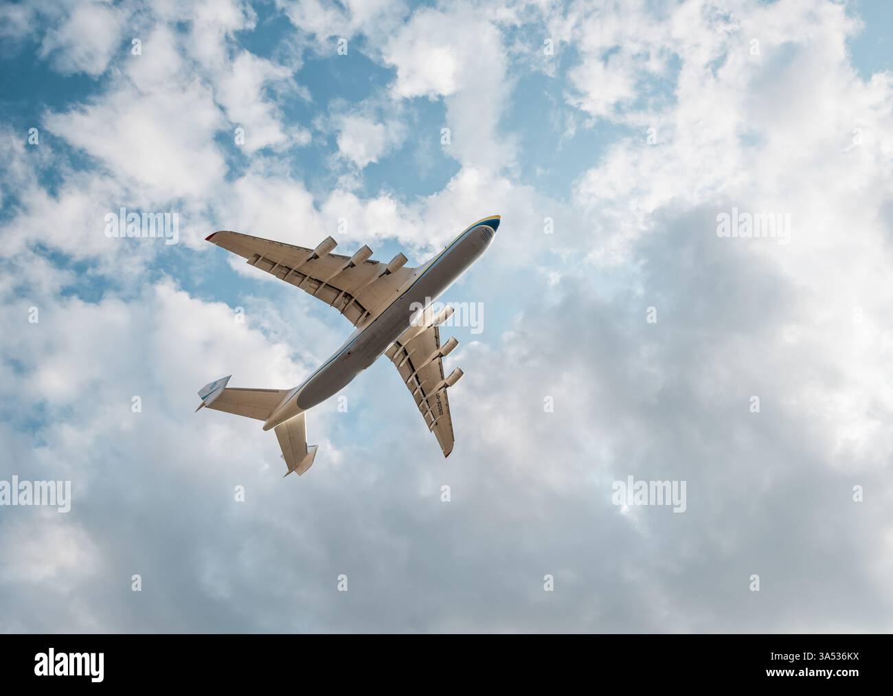 The underside of An-225 flying against cloudy sky. Looking up at the ...