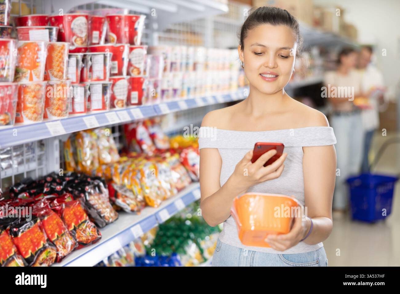 Woman scans qr code with smartphone on label of traditional chinese ...