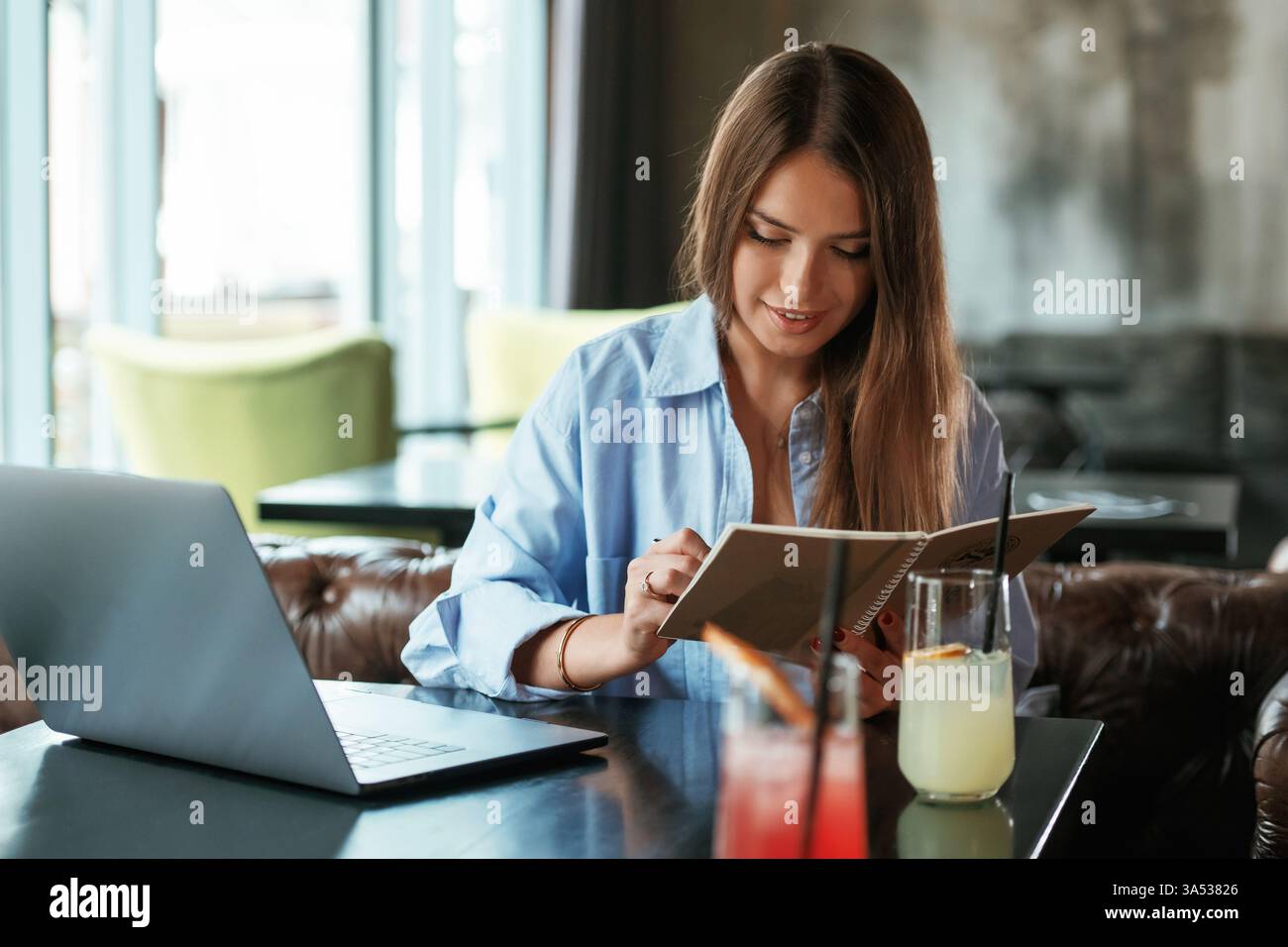 Focused at work. Beautiful woman with laptop is in the bar Stock Photo ...