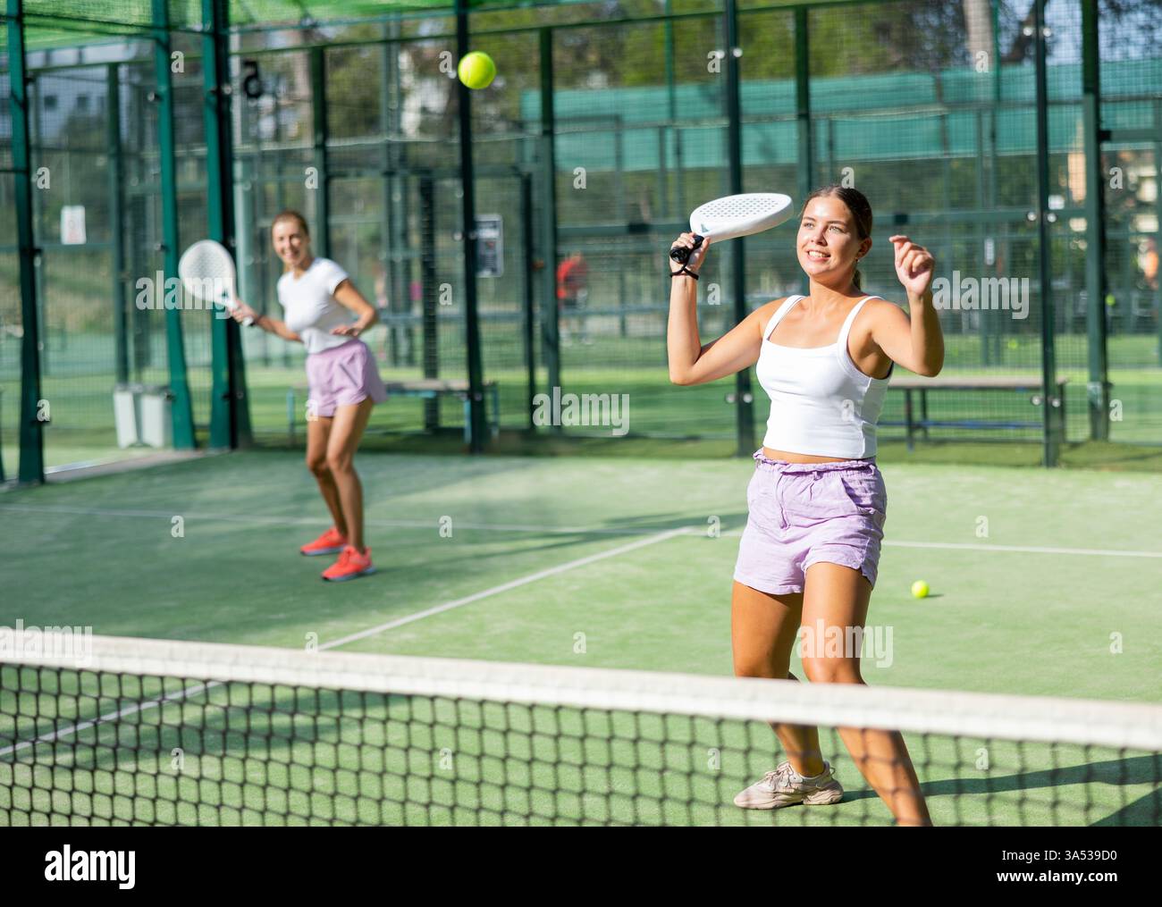 Two women tennis players playing padel Stock Photo - Alamy