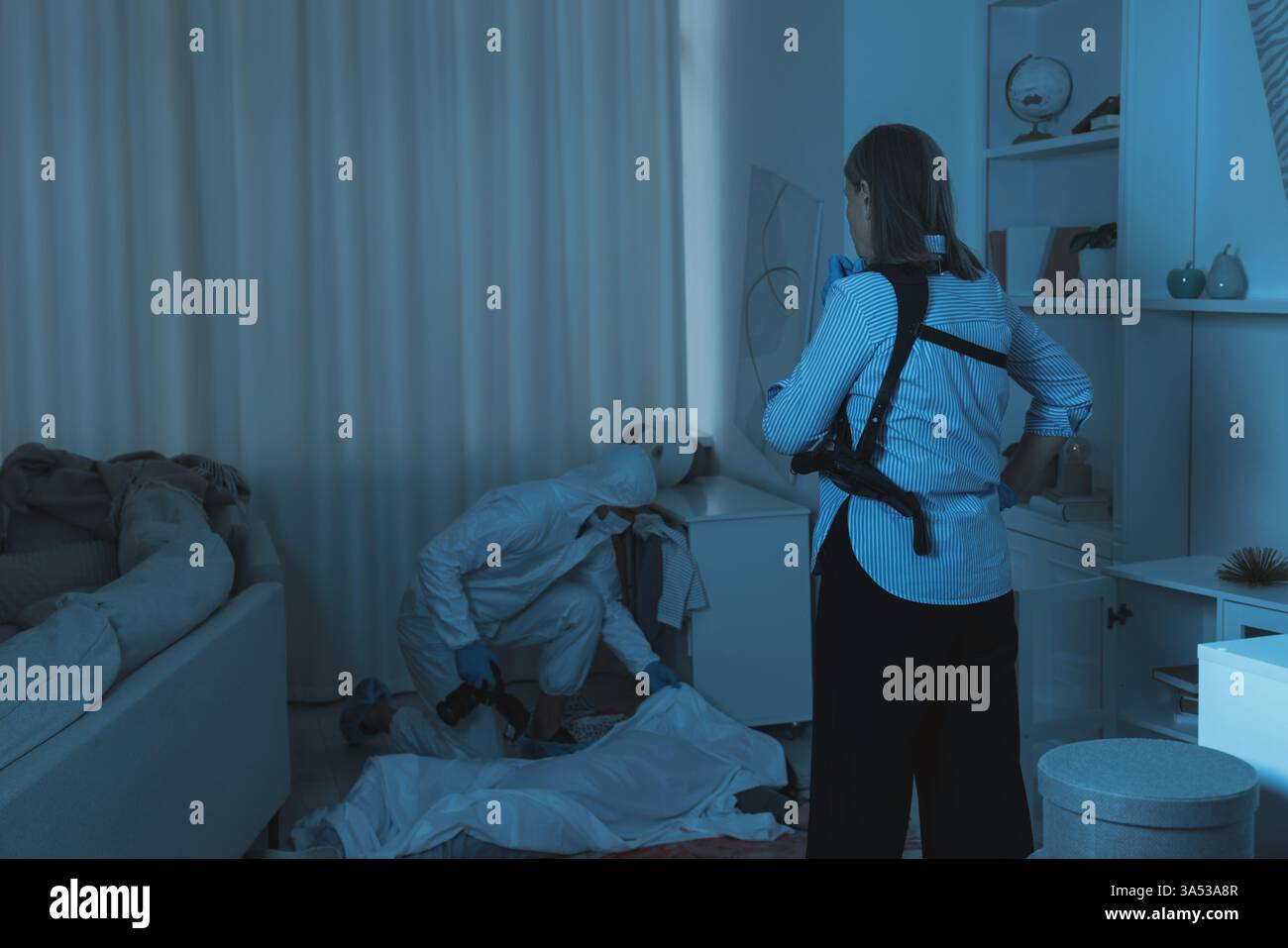 Forensic experts working at crime scene with dead woman's body indoors ...