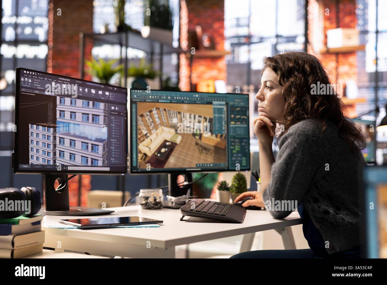 Female employee at design agency creates 3D render of an apartment ...