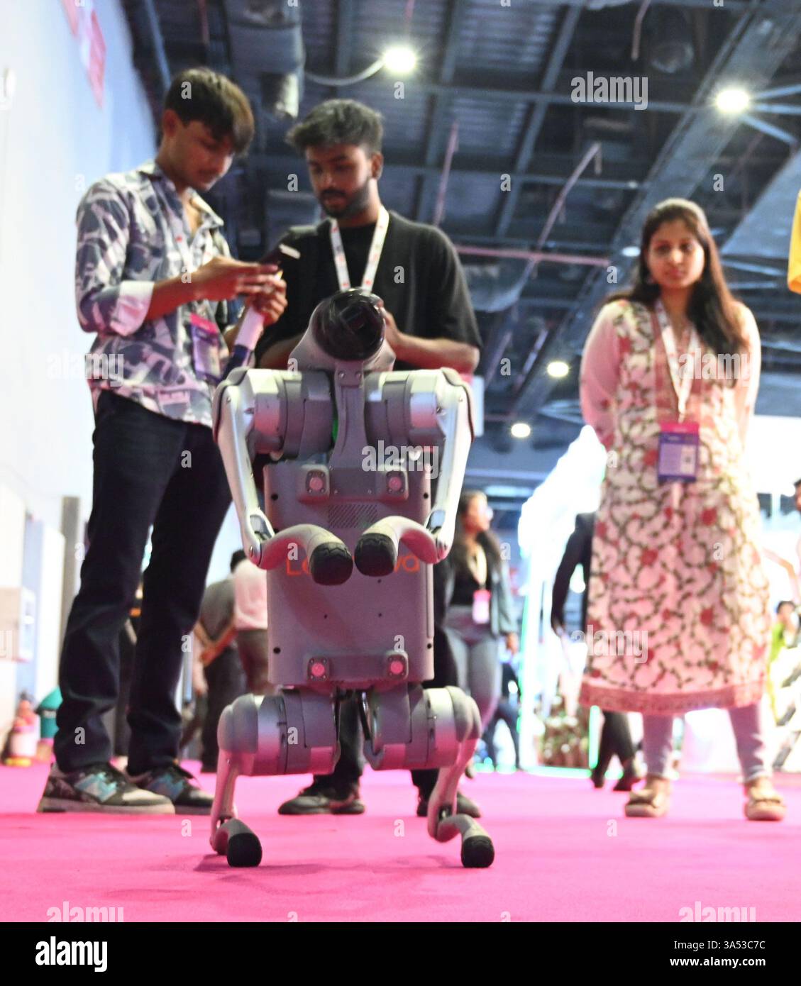 NEW DELHI, INDIA - MARCH 19: Visitors interacting with Cyberdog Robot ...