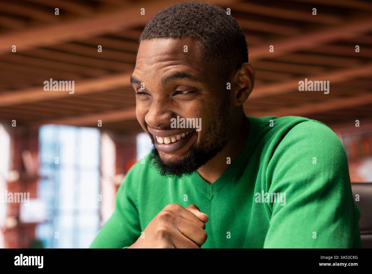 Joyful cheerful african american man at home celebrating, showing ...
