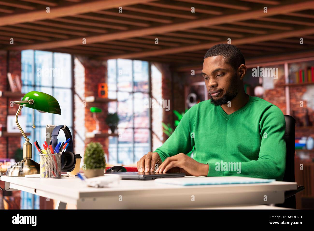 Remote employee in home office closing laptop after finishing catching up with emails ...