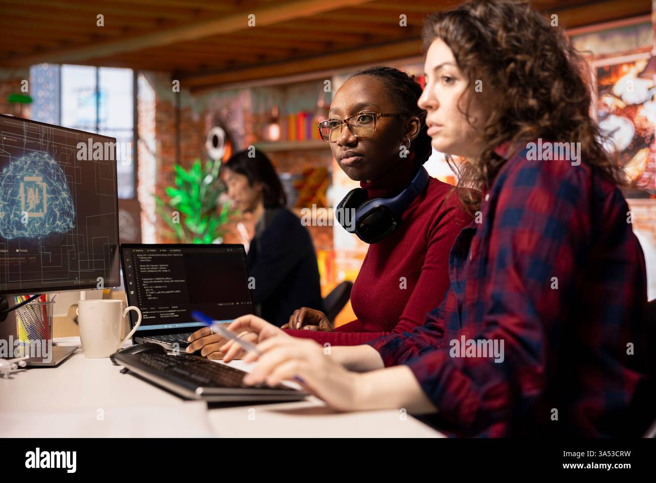 Colleagues doing teamwork in designing hi-res stock photography and ...