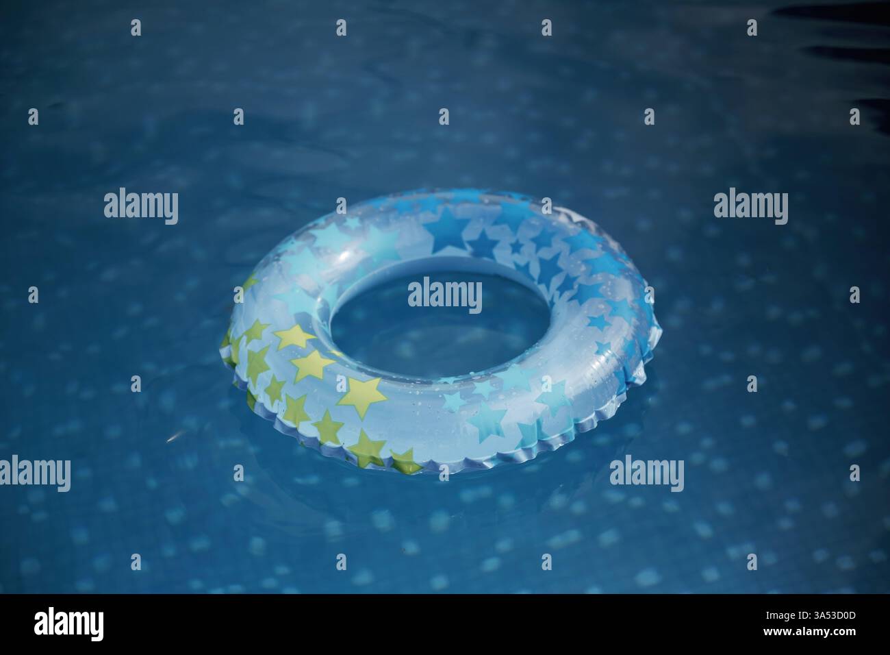 Lifebuoy for kids is on the surface of the water in the swimming pool ...