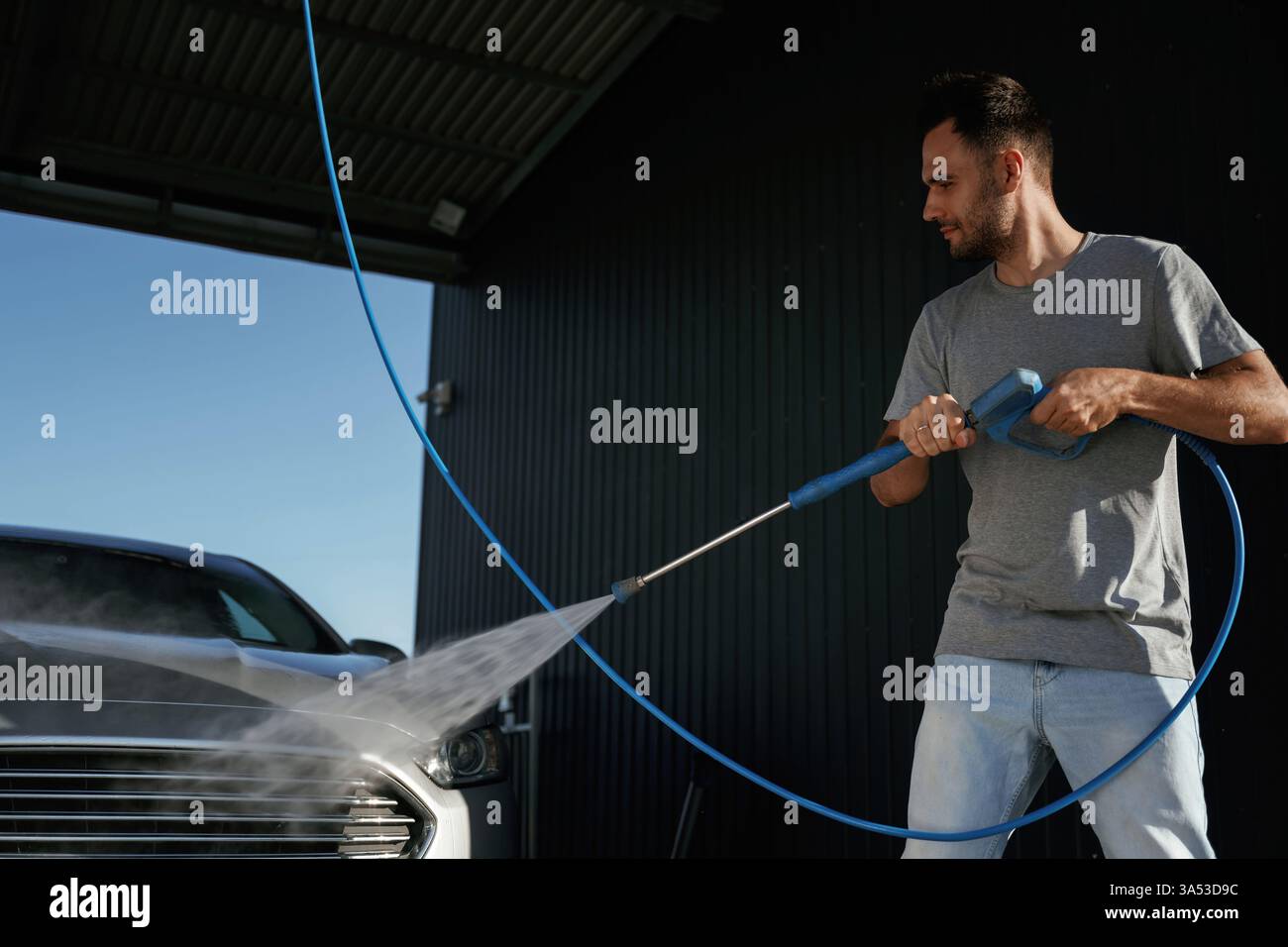 Taking care of washing. Man is with his car outdoors Stock Photo - Alamy