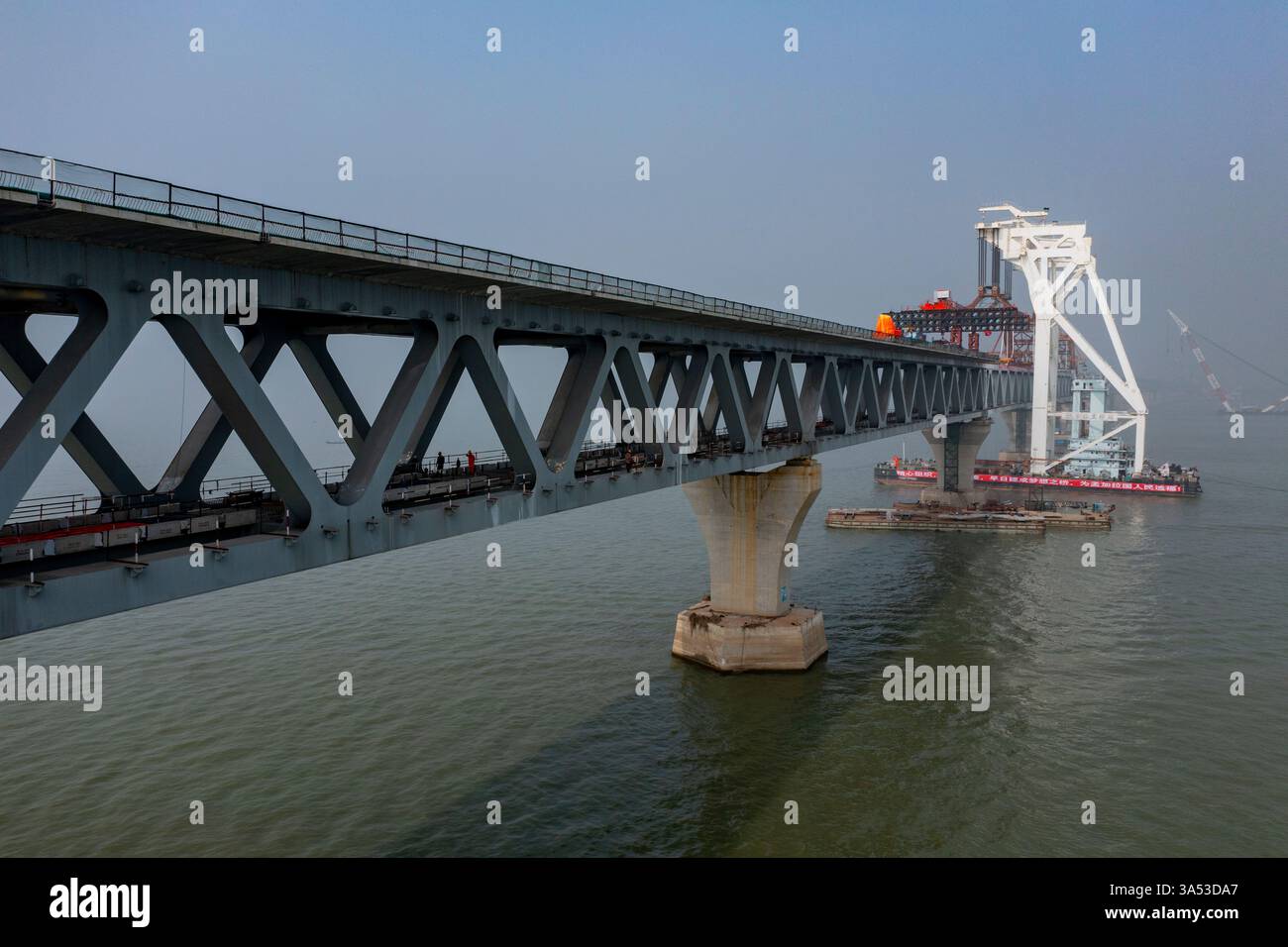 An aerial view of the final span being installed on pillars 12 and 13 ...