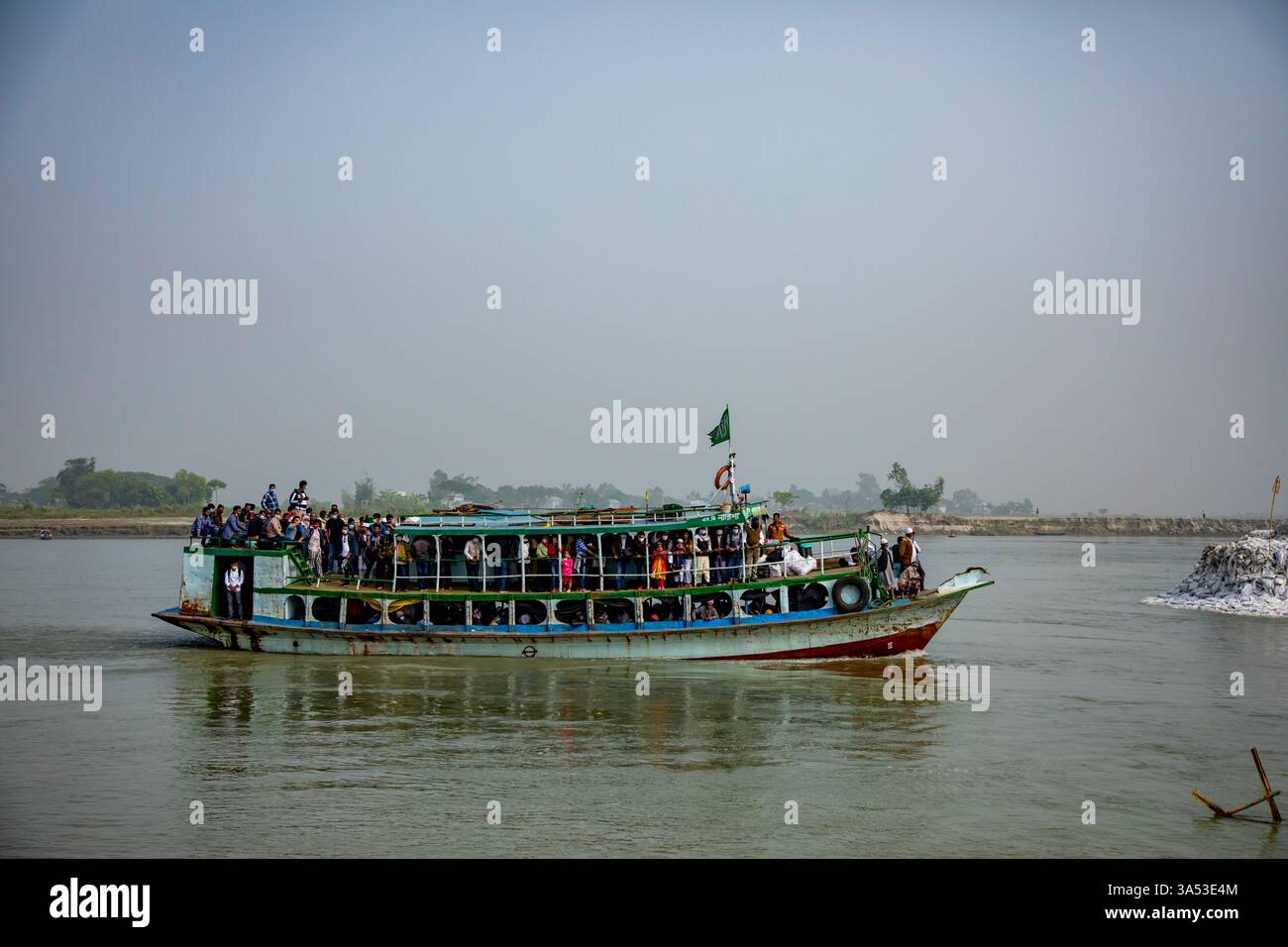 A ferry navigates beneath the Padma Multipurpose Bridge, which spans ...