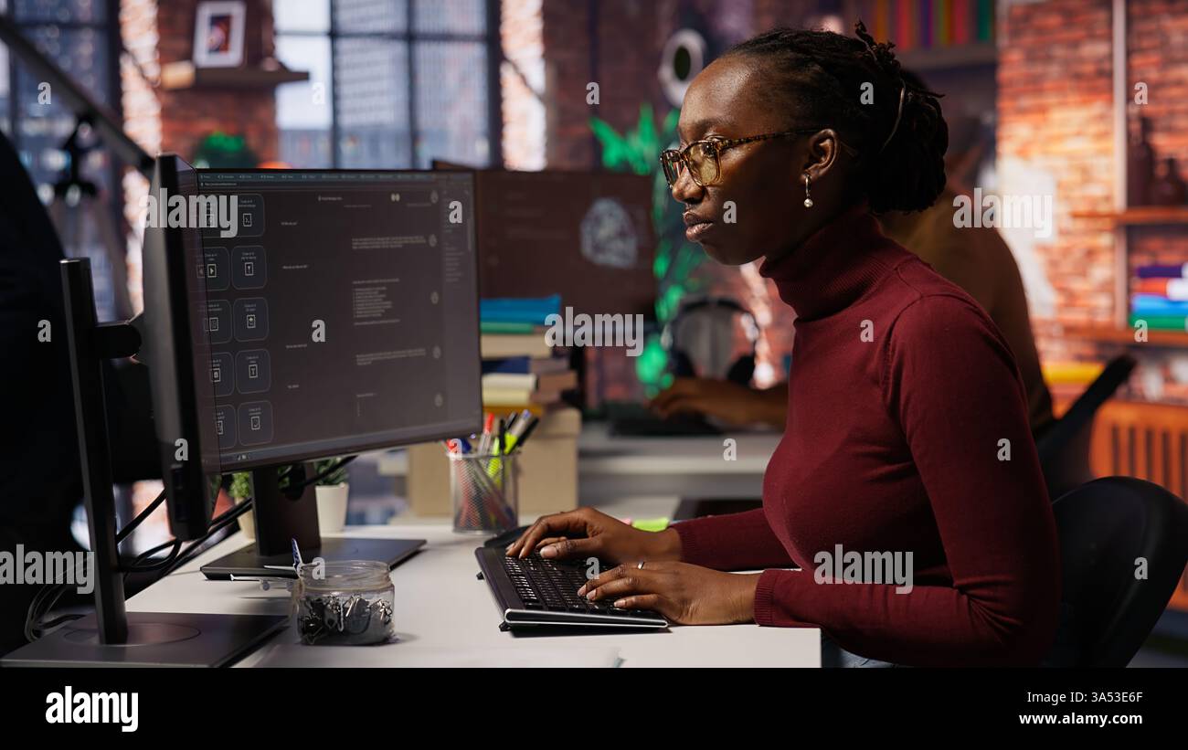 IT startup worker using large language model application to get help with coding tasks. Woman ...