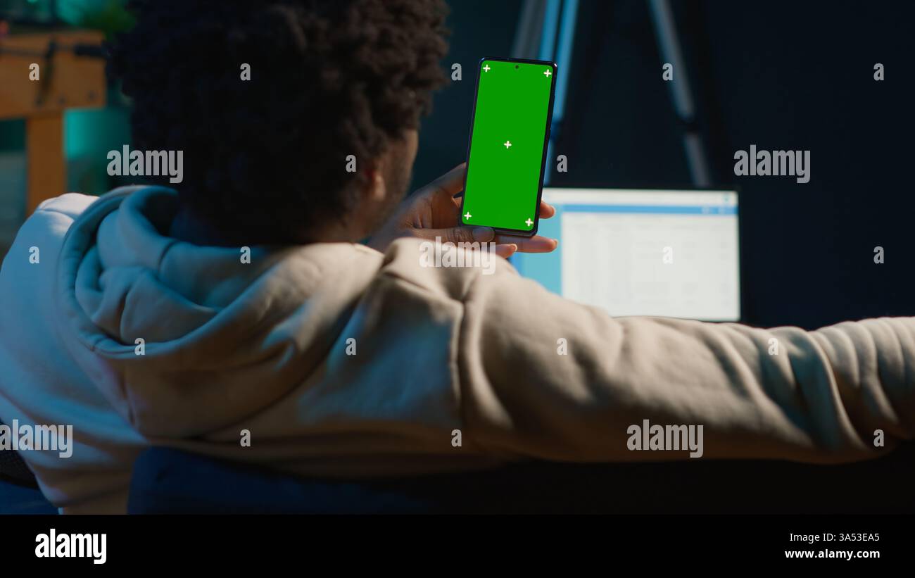 Confident tech user looking at isolated mockup display in his living ...