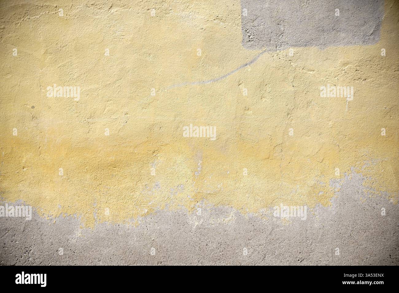 close-up-of-a-yellowed-facade-and-peeling-layers-of-plaster-stock-photo