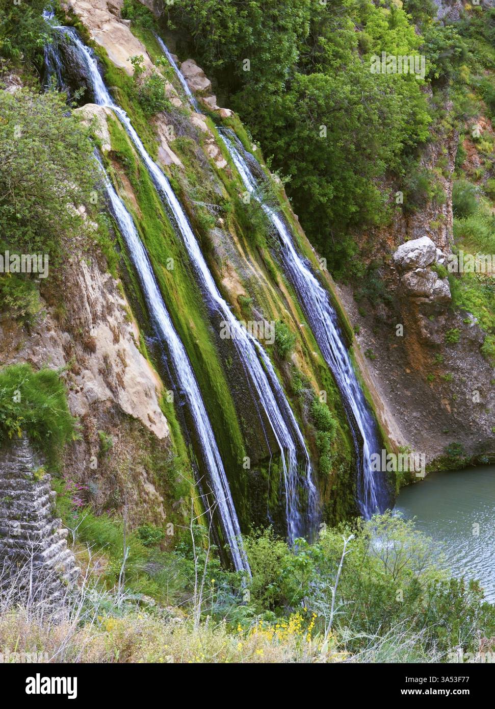 Unusual waterfall. Three parallel stream running down the steep slope ...