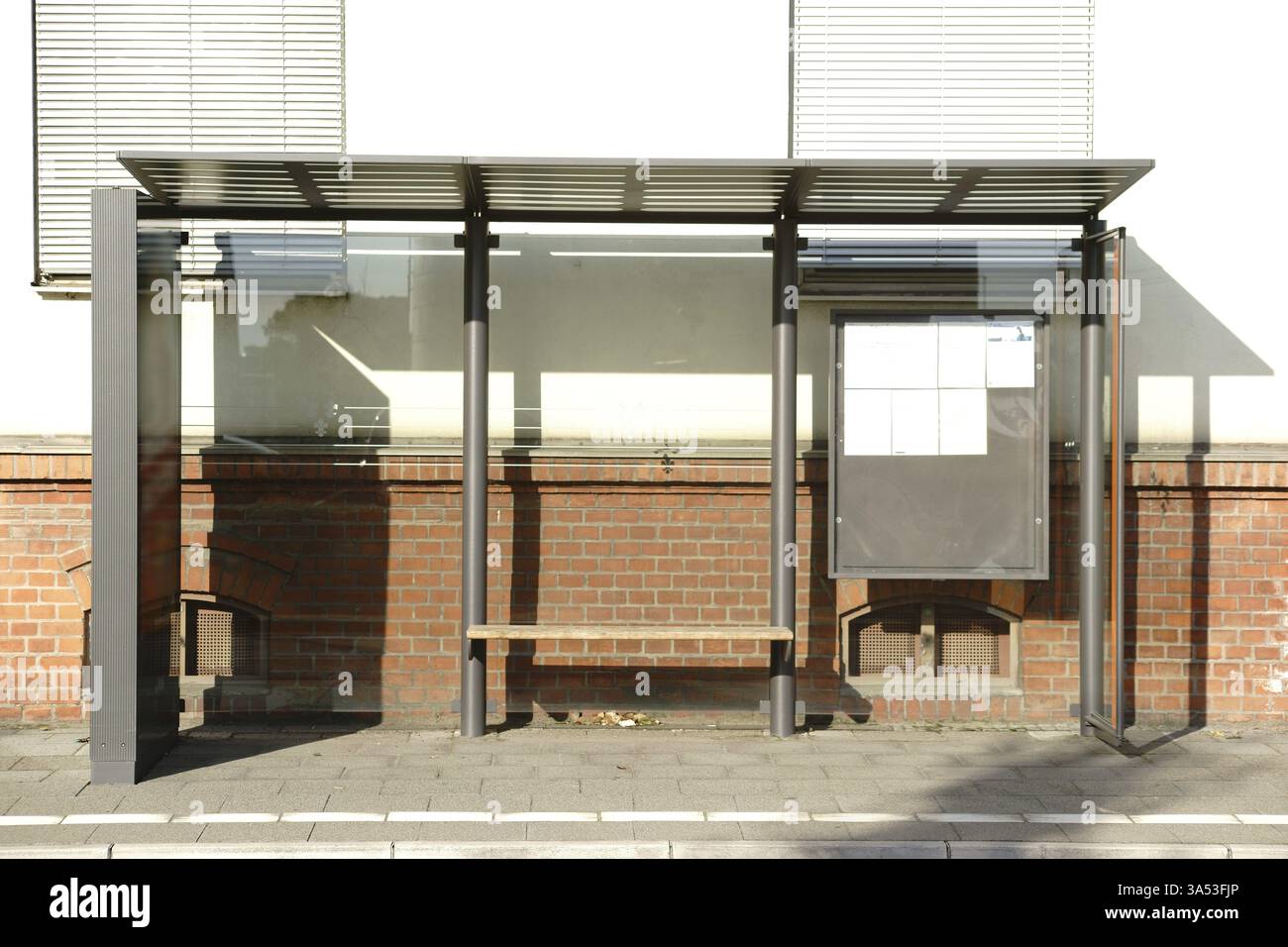 A bus stop casts geometrically abstract shadows on the wall Stock Photo ...