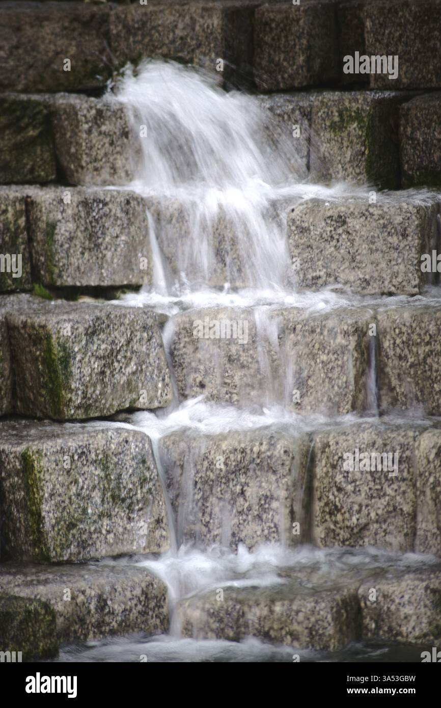 Water flows down the stone steps of a fountain Stock Photo - Alamy