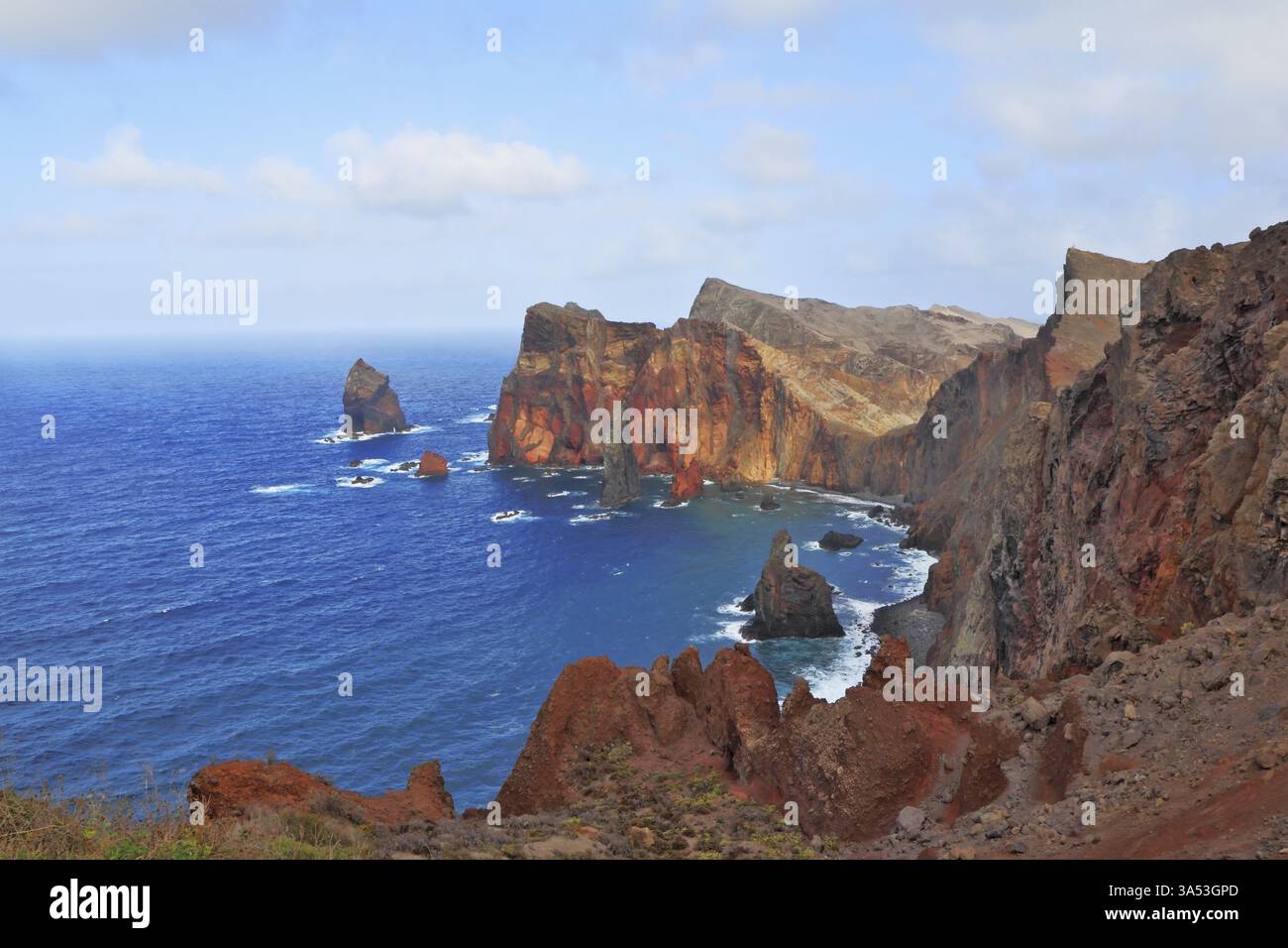Red rocks and blue sea. Eastern end of Madeira Island at sunset ...