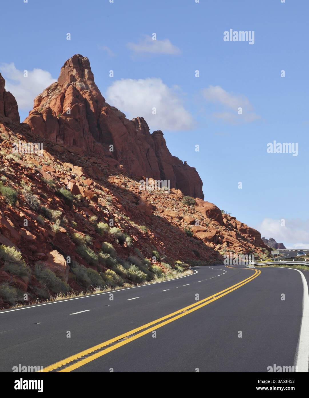 The magnificent marked American road passes between rocks of red ...