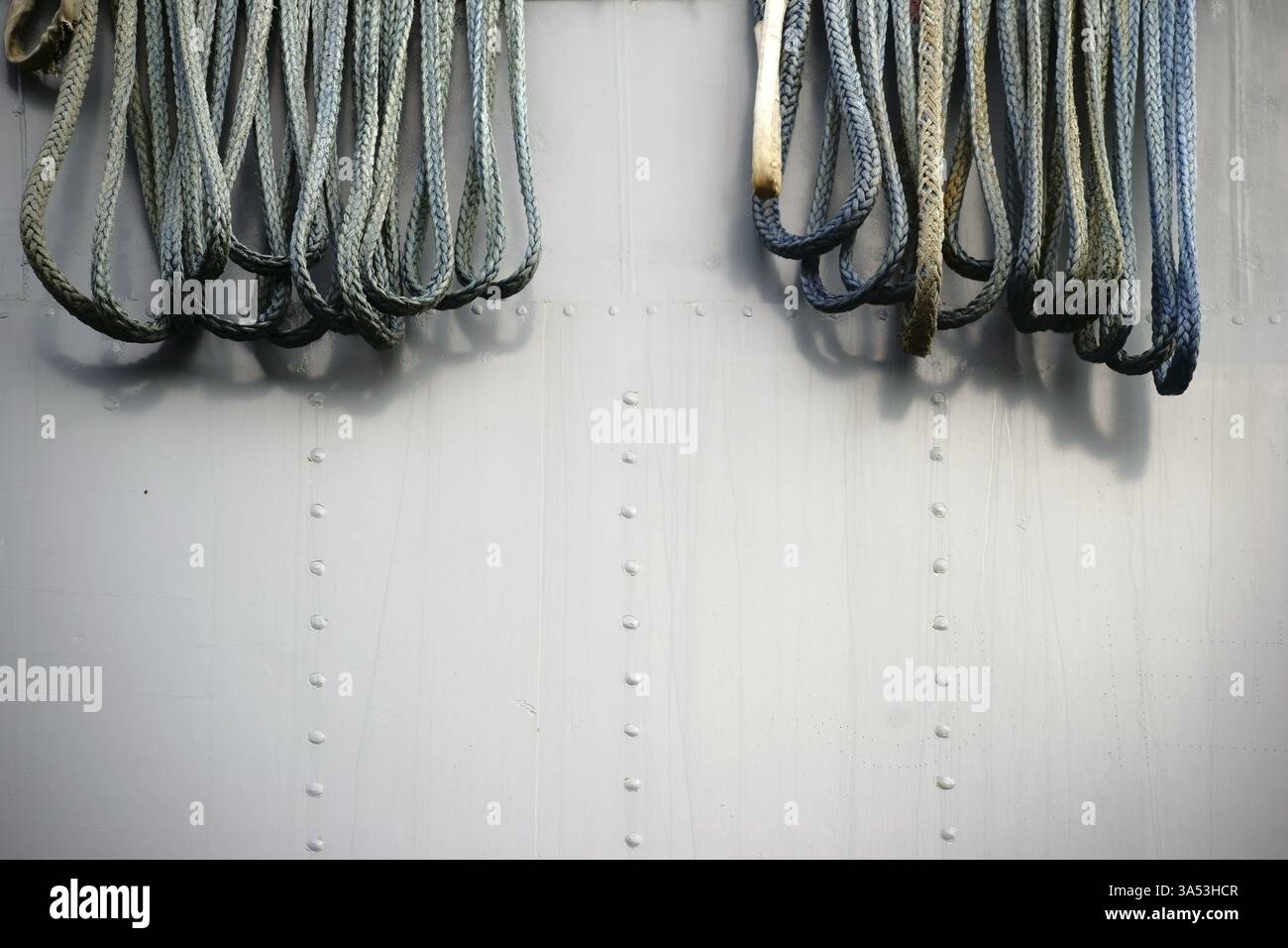 Ropes hanging tidily from the railing of a tanker on the ship's side ...