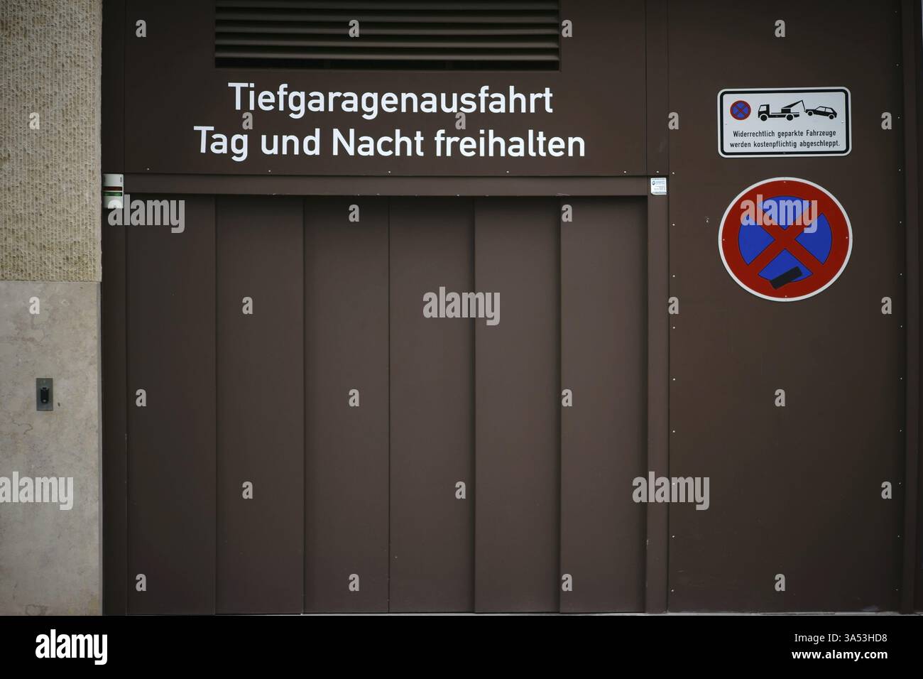 The exit of an underground car park with traffic signs and a sliding ...