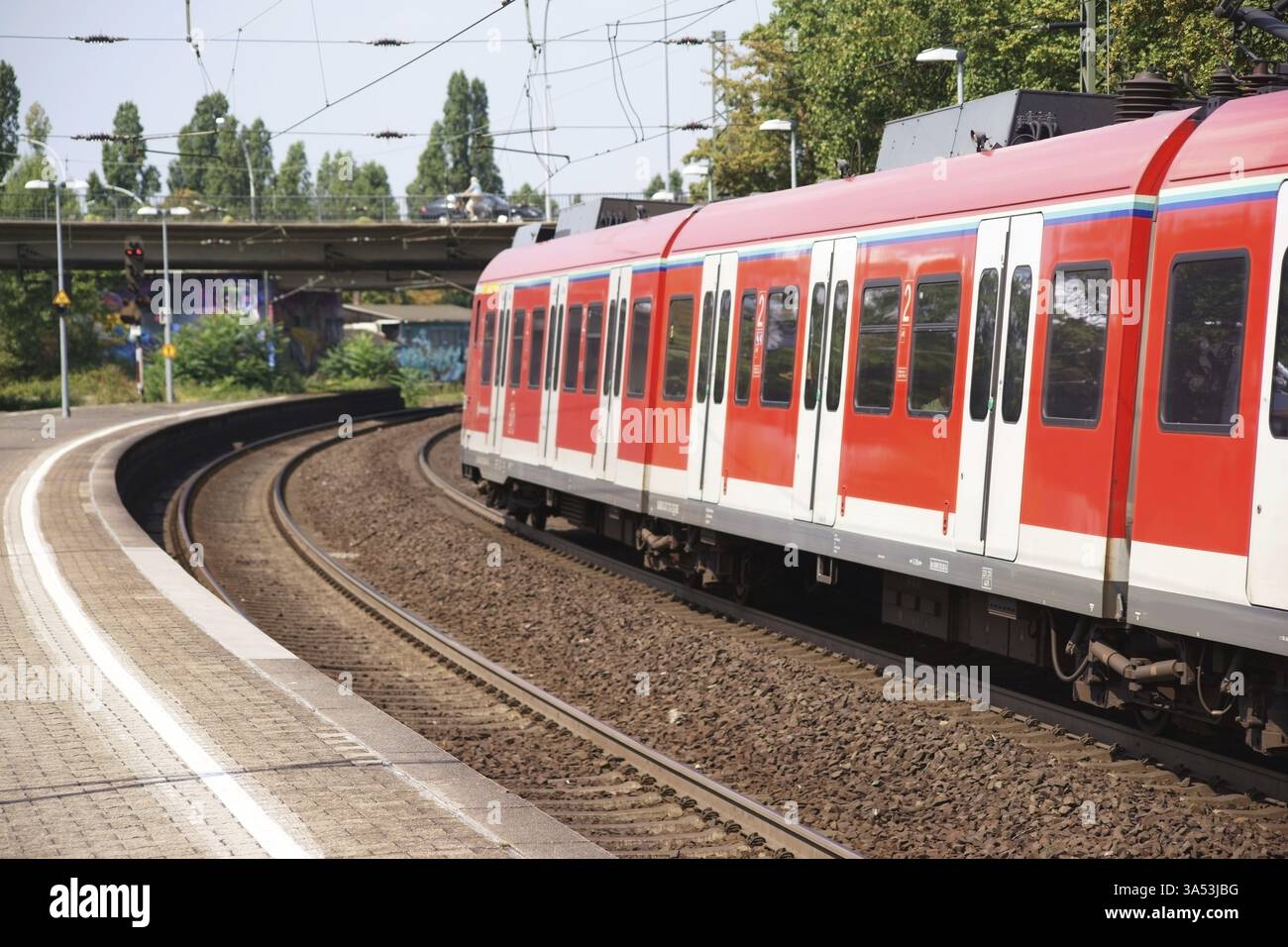 The curve of a platform with a passing train Regional train Stock Photo ...