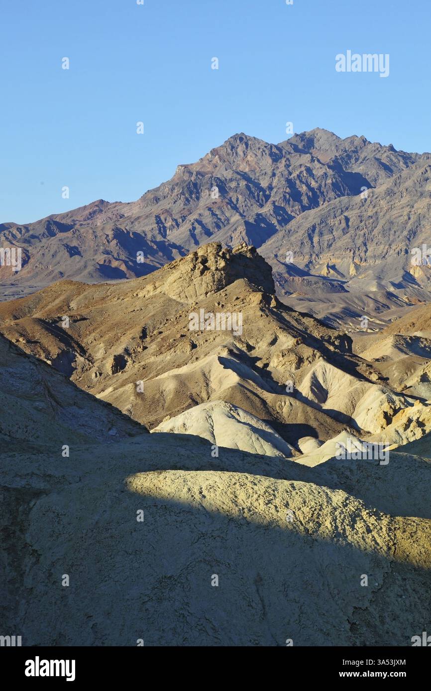 Early evening in Death Valley. Long shadows of the ancient picturesque ...
