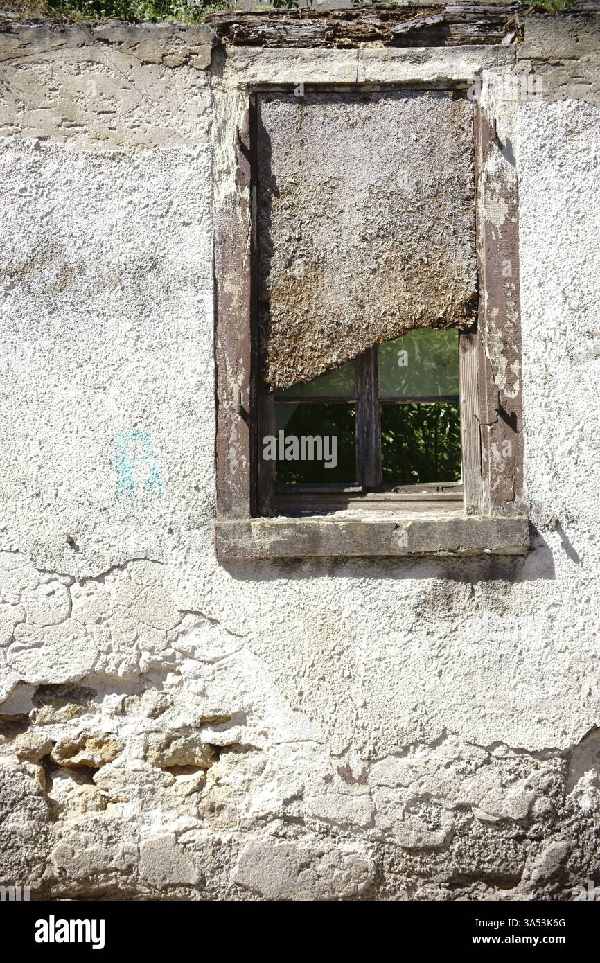 A boarded-up window of a ruin in danger of collapsing Stock Photo - Alamy