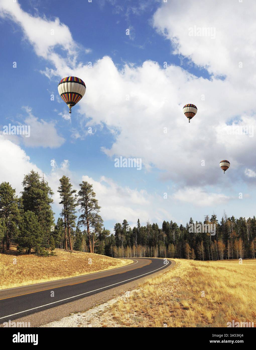 Huge balloons with a passenger basket fly over charming rural road ...