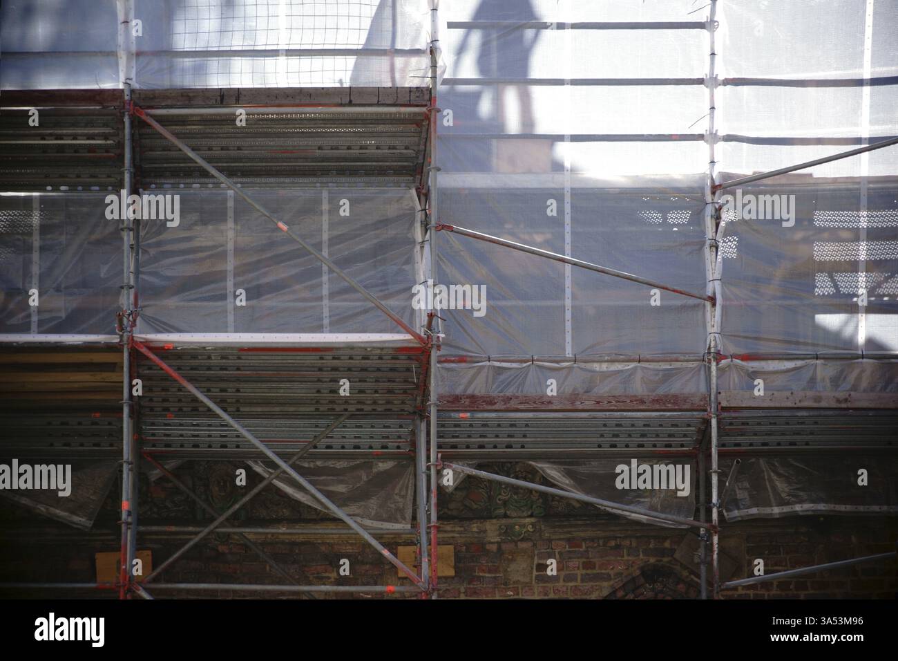 The silhouette and shadow of a construction worker during a restoration ...