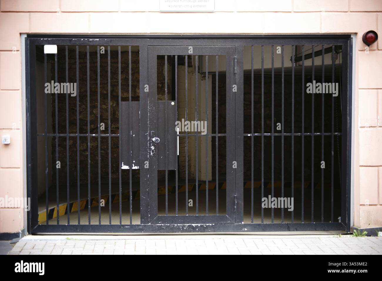 The barred exit of an underground car park with traffic signs and a ...