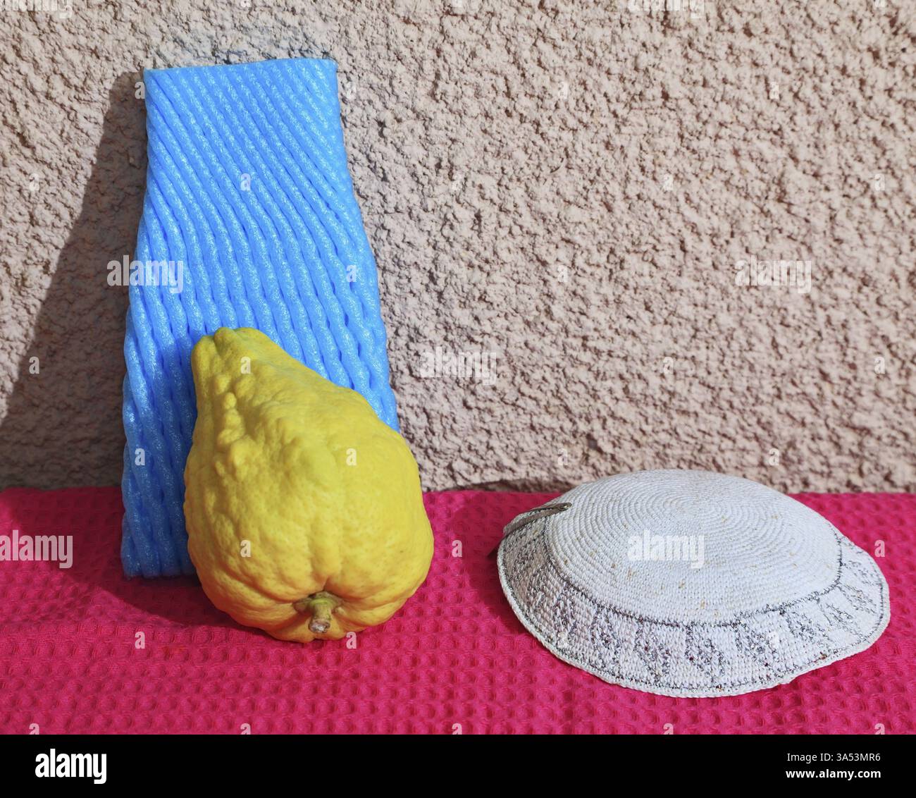 Jewish holiday of Sukkot. White skullcap and ritual etrog fruit on ...