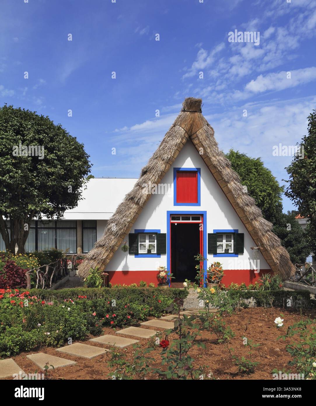 Pastoral landscape. Cosy chalet with a triangular thatched roof. Before ...