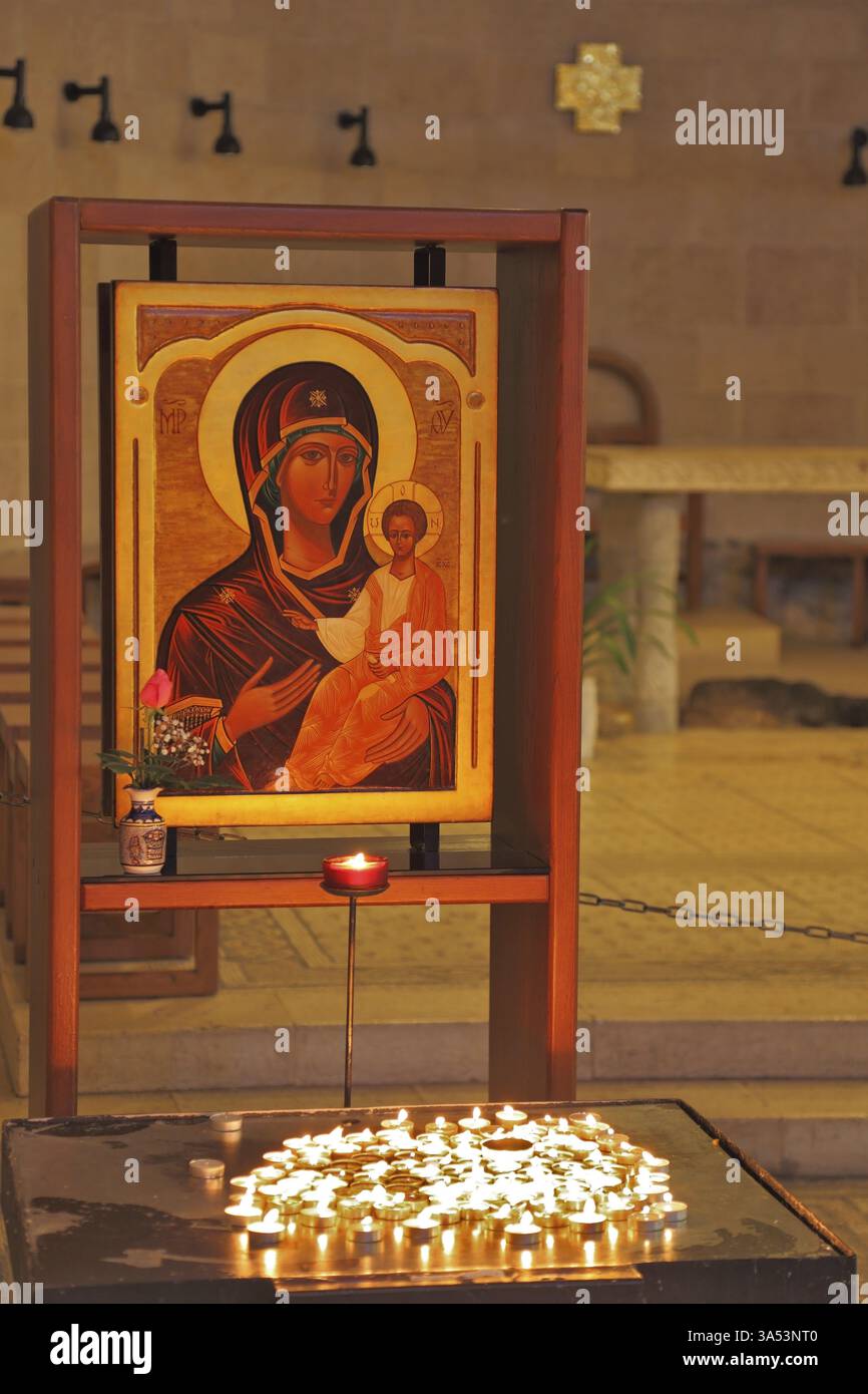 Magnificent old icon of Jesus Christ, and a table with burning candles ...