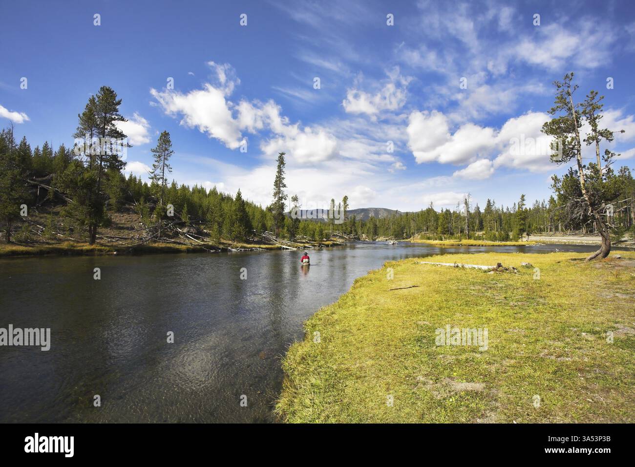 The fisherman in a red jacket with a fishing tackle will fish in the ...