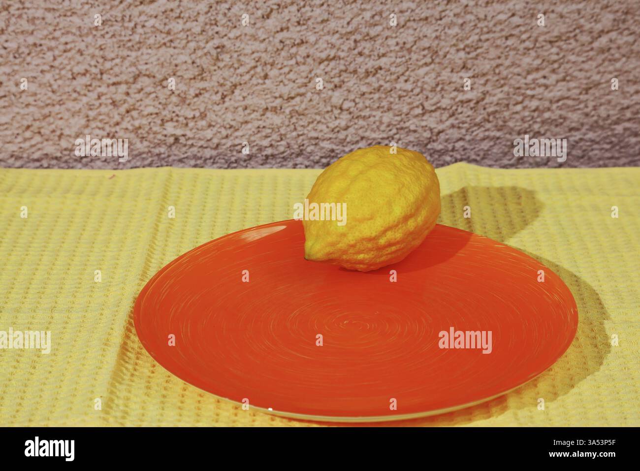 Ritual fruit - citron on orange plate and yellow napkin. Jewish holiday ...