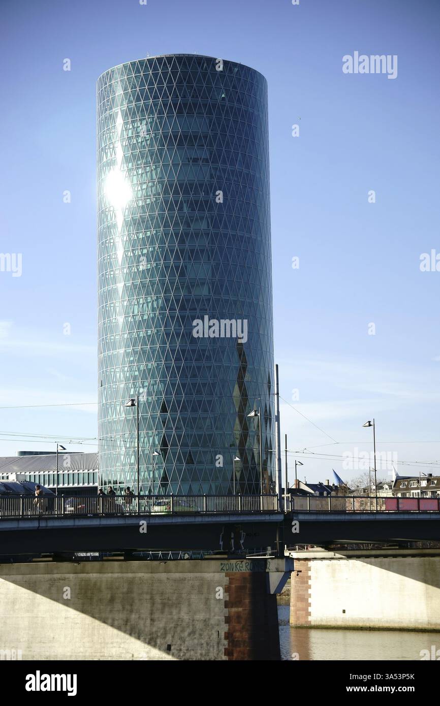 The modern glass facade of the Westhafen Tower in the sunlight and ...