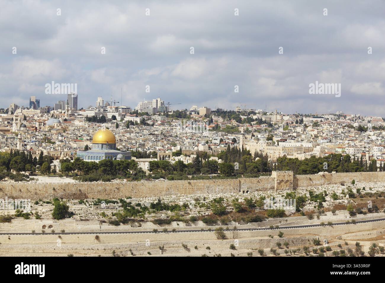 A gold dome and blue walls of a Muslim mosque and a modern city with ...