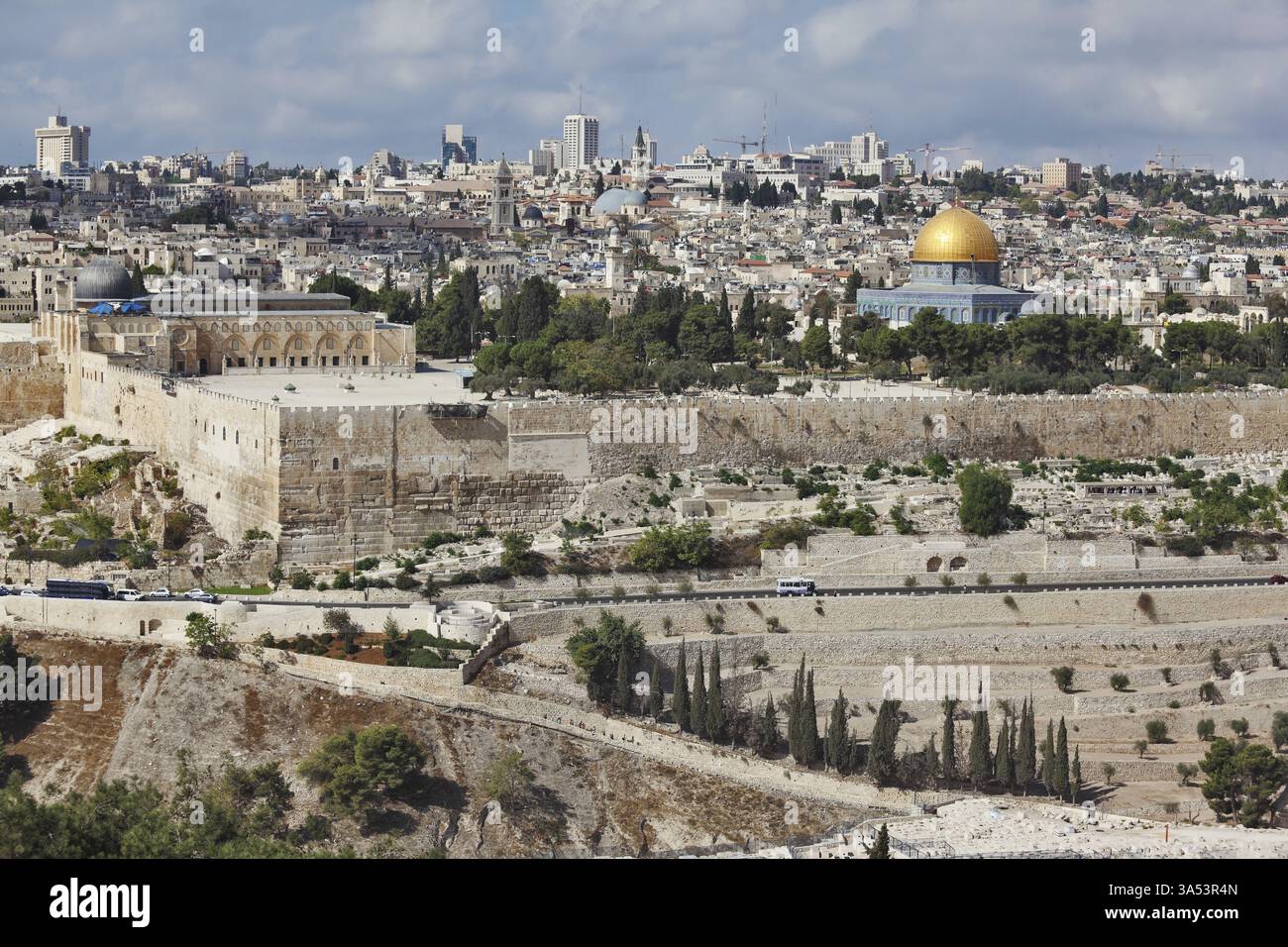 A gold dome and blue walls of a Muslim mosque and a modern city with ...