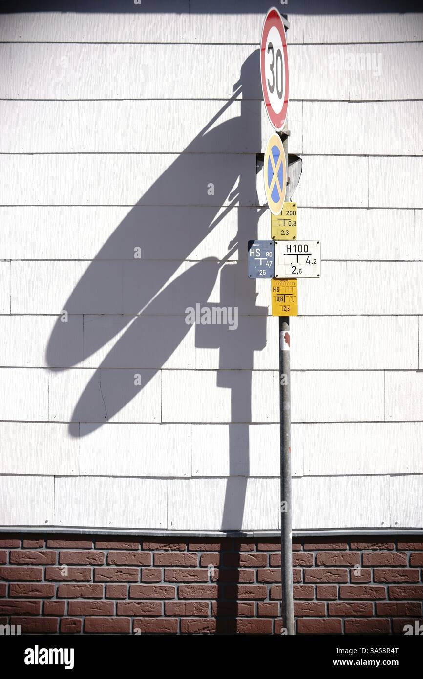 A vertical no stopping and speed limit sign with water and gas ...
