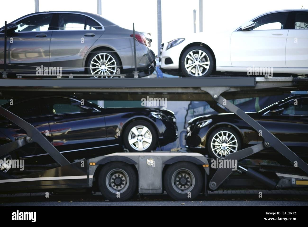 A trailer loaded with several cars on a lorry Stock Photo - Alamy