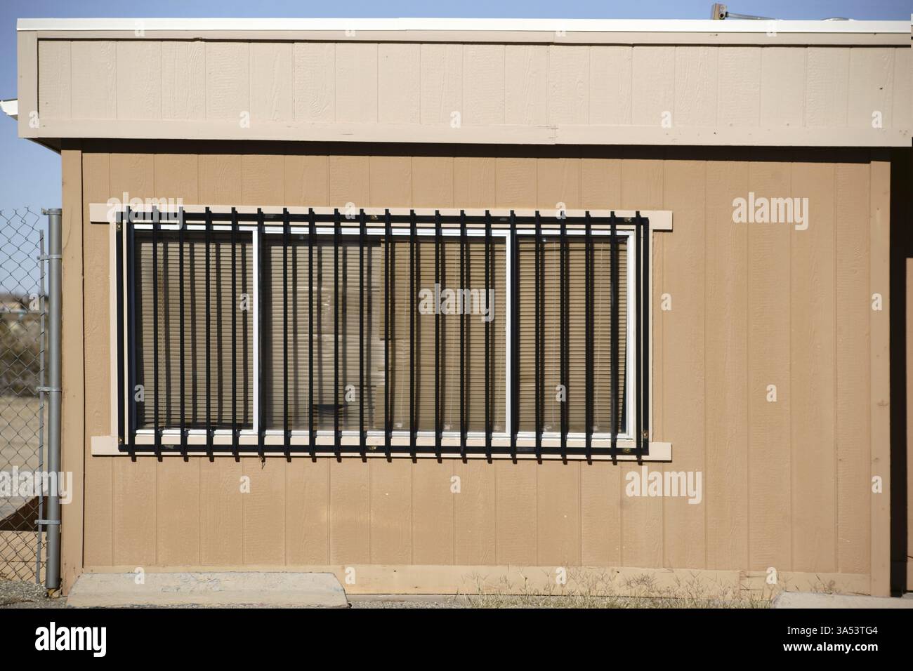 A window with a window grille on a plain square building Stock Photo ...