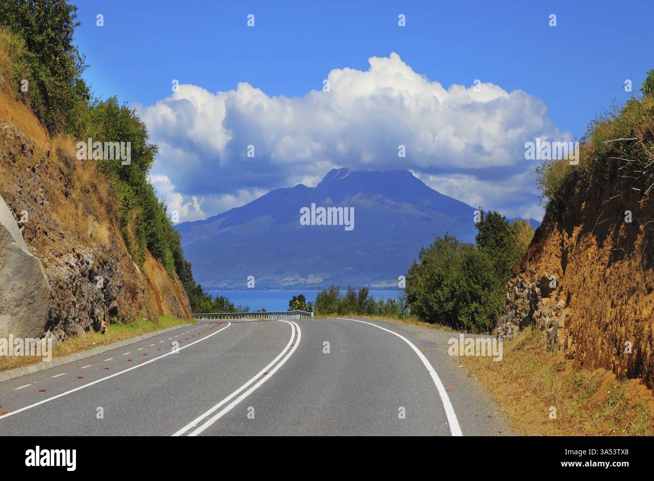 The road leads to the famous volcano Osorno. Top of the volcano cloud ...