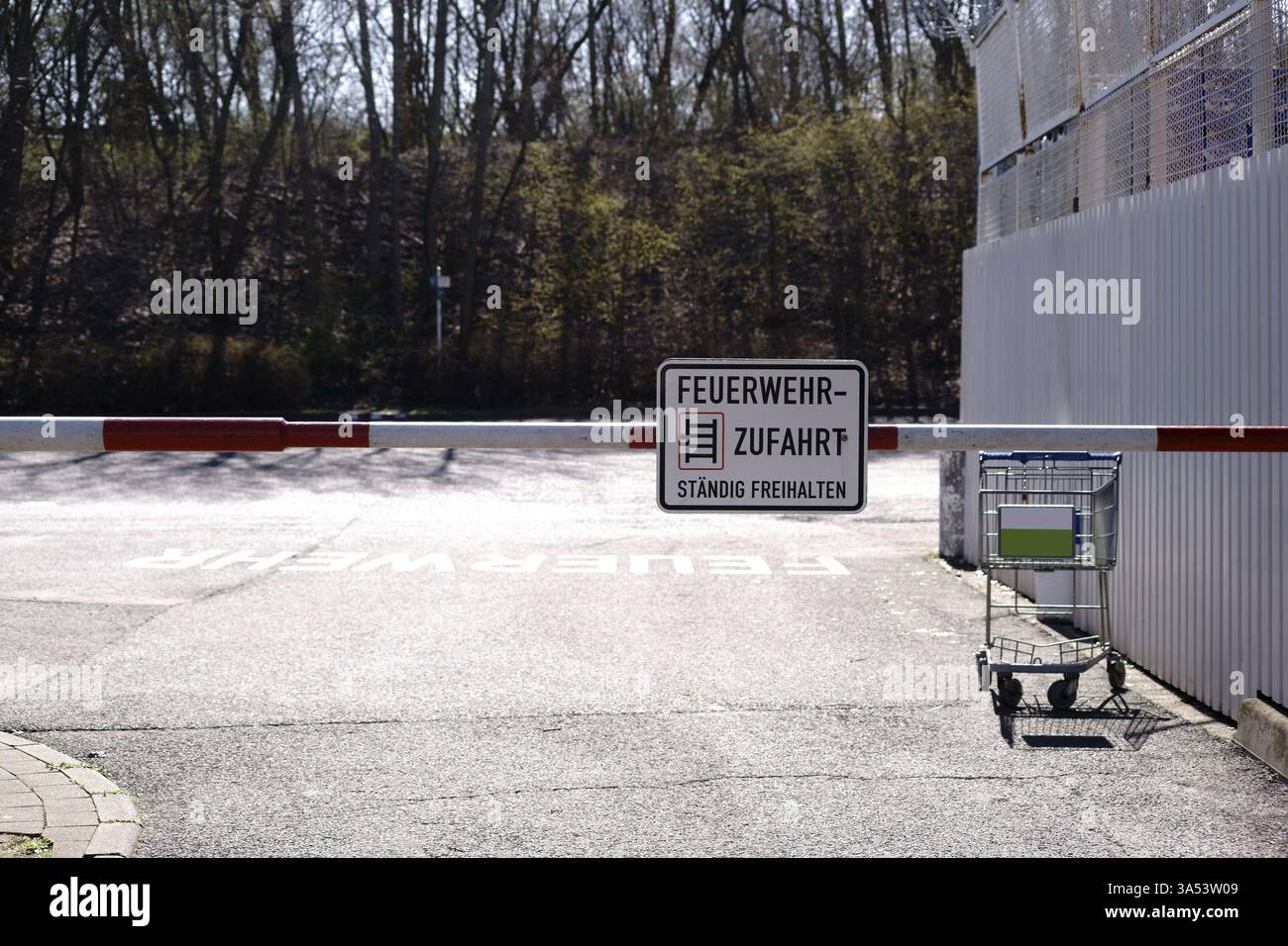 A closed barrier at the entrance to the rear courtyards of a shopping ...