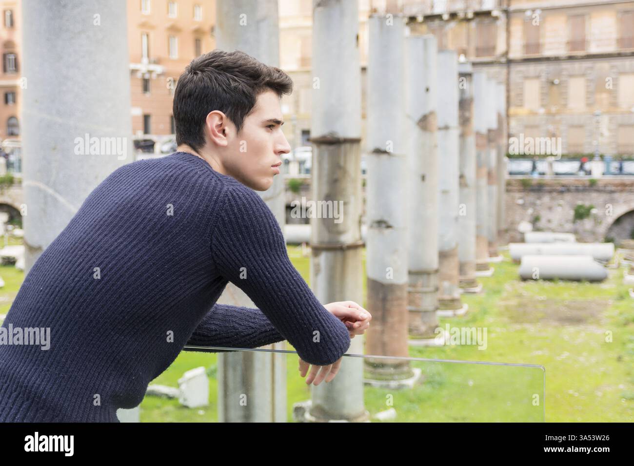 Attractive young man in Rome, Italy, looking at ancient ruins and ...