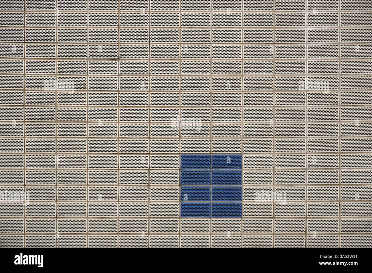 The modern facade of a building with angular clinker bricks with grid ...