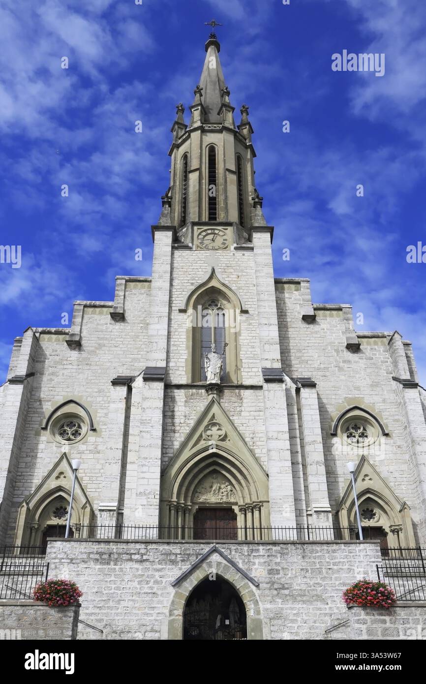 The majestic facade of the Catholic cathedral. Slender bell tower ...